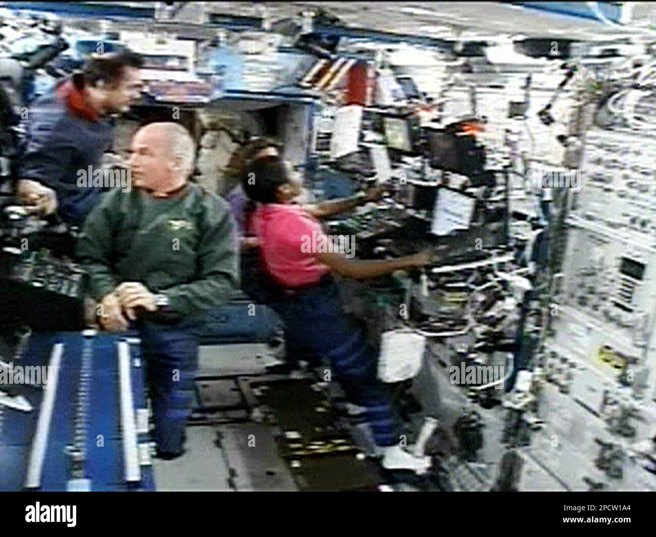 In this image made from NASA TV, astronauts Jeff Williams, second from ...