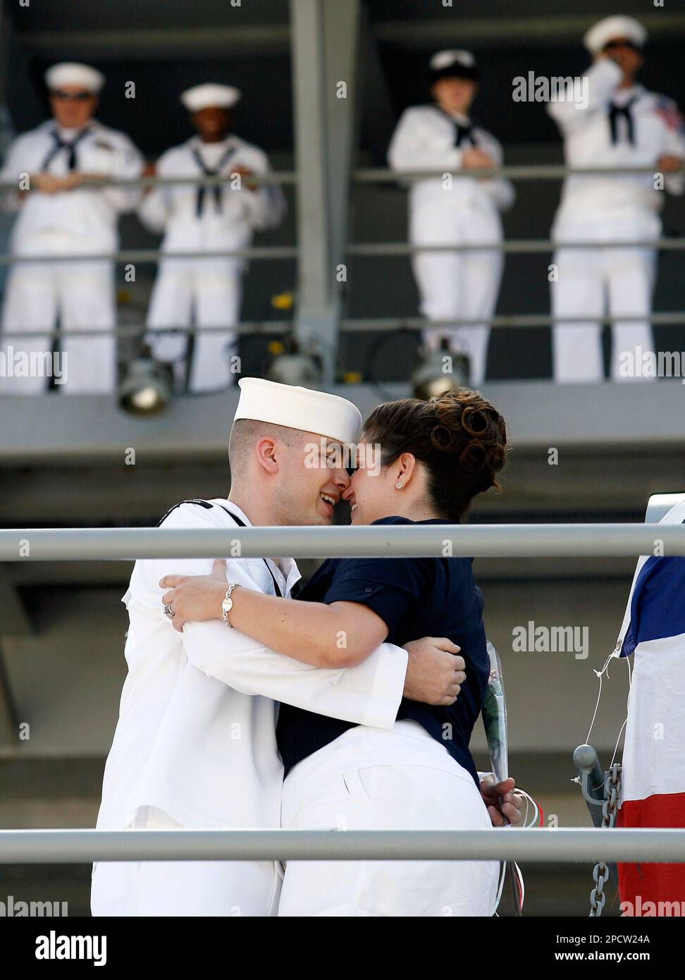 Sailor Ryan Gorman kisses his wife, Rachel, as the USS Ronald Reagan ...