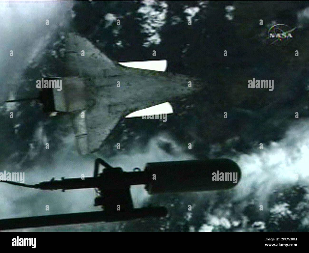 In this image made from NASA TV, astronauts aboard the Space Shuttle ...