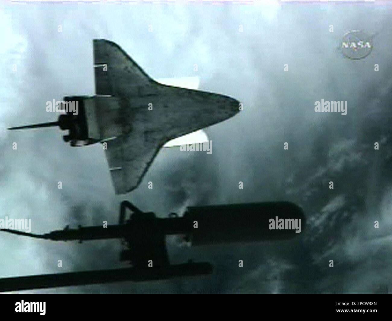 In this image made from NASA TV, astronauts aboard the Space Shuttle ...