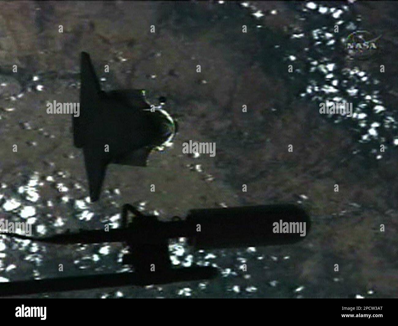 In this image made from NASA TV, astronauts aboard the Space Shuttle ...