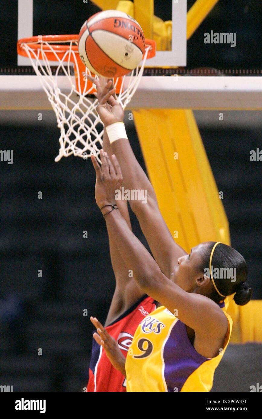 Los Angeles Sparks' Lisa Leslie, right shoots over Houston Comets ...
