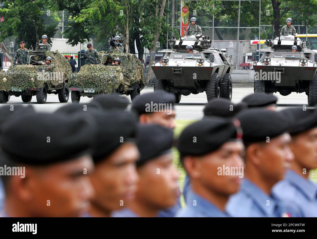 Philippine National Police march with their armoured personnel carriers ...