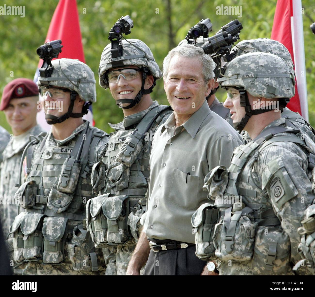 President Bush smiles as he poses for a group photo with military ...