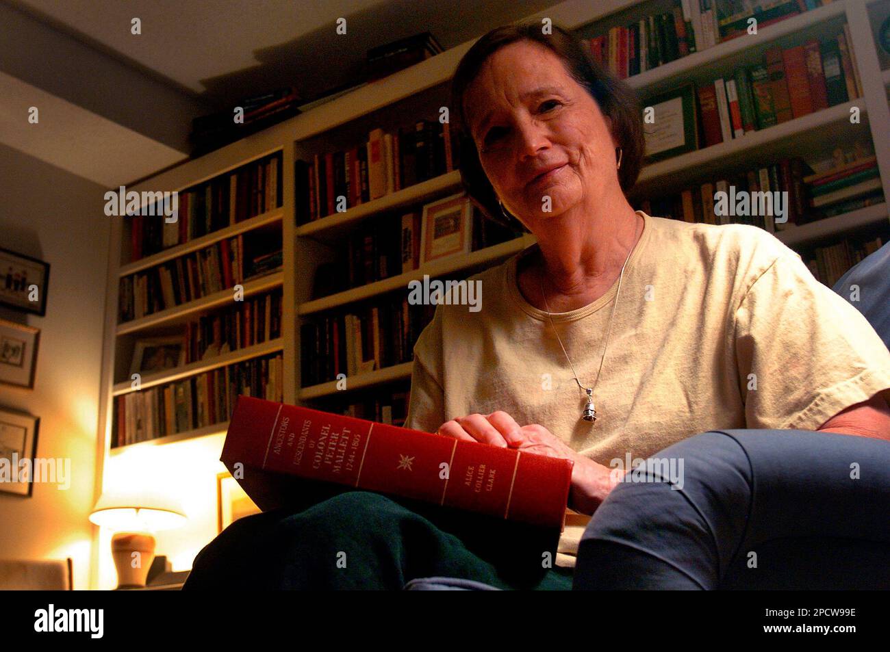 Harriet Hooper sits in her living room with a book which includes ...