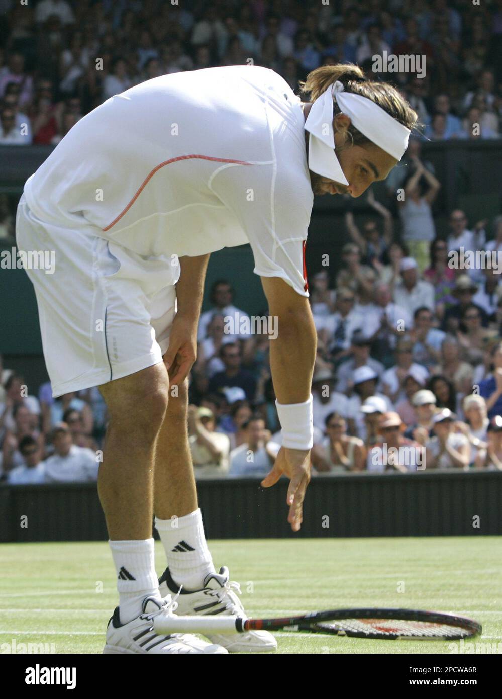 Marcos Baghdatis of Cyprus throws his racket during his match with ...