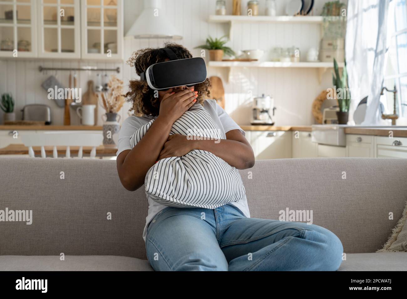 Shocked African American woman in virtual reality goggles feel scared ...