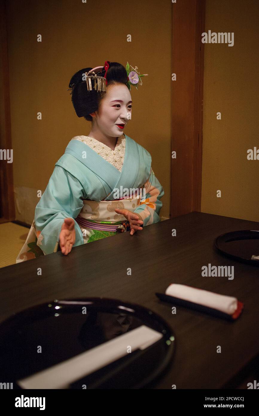 'maiko' (geisha apprentice)working in a tea house.Geisha's distric of ...