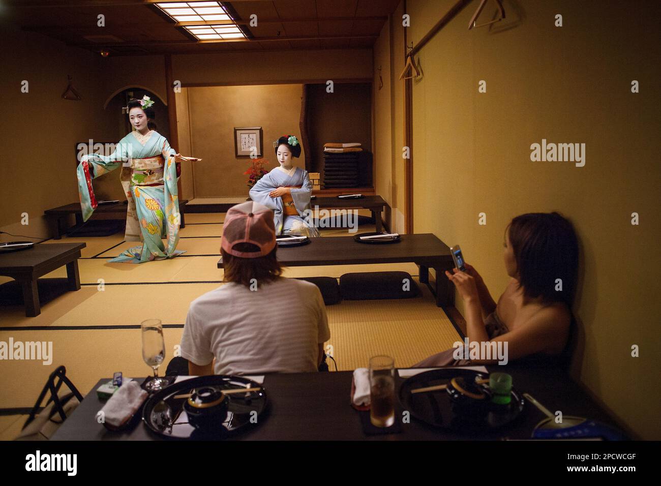 'maikos' (geisha apprentice) dancing in a tea house.Geisha's distric of ...