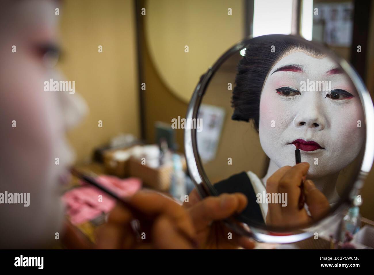 Toshiyu applying makeup in her Okiya (geisha house).Geisha from geisha ...