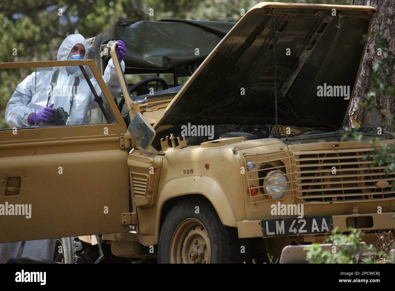 An investigator examines a British military Land Rover that crashed ...