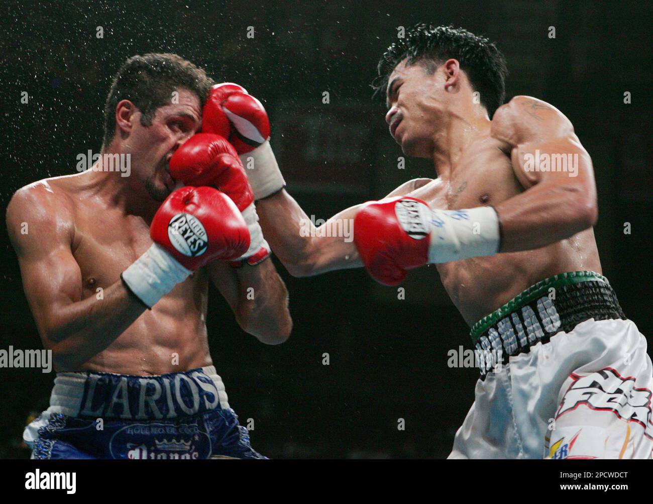 Philippine boxing champion Manny Pacquiao, right, connects with a right ...