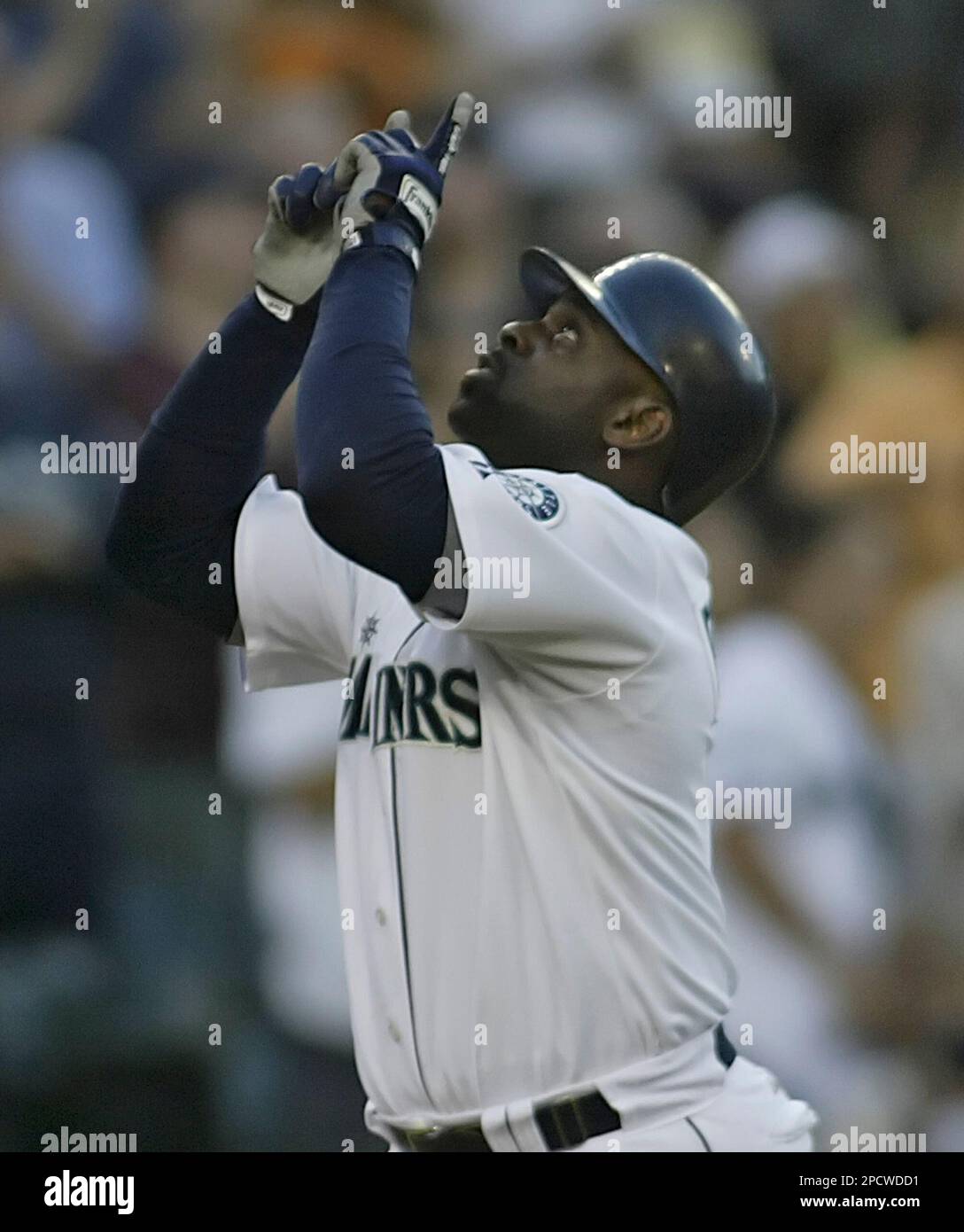 Seattle Mariners' Carl Everett points skyward after hitting a two-run ...