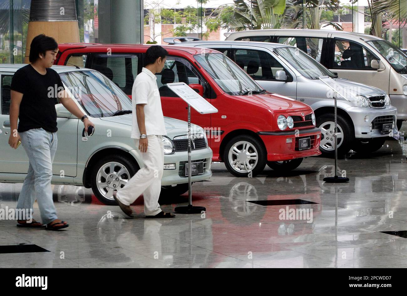 Visitors look at Perodua cars on display at the Perodua headquarters in ...