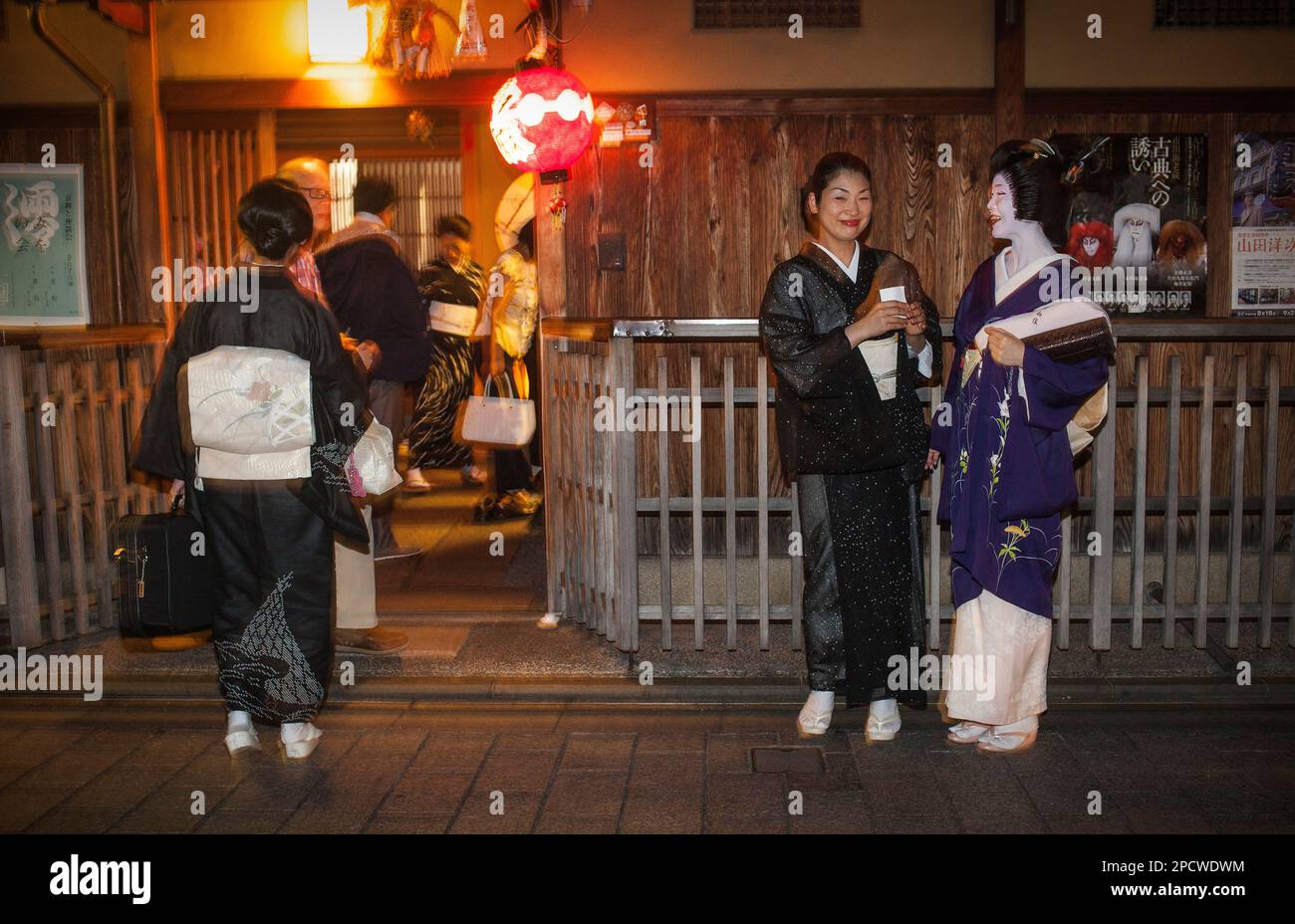 Geishas and clients in the entrance of Ochaya (tea house). Hanamikoji ...