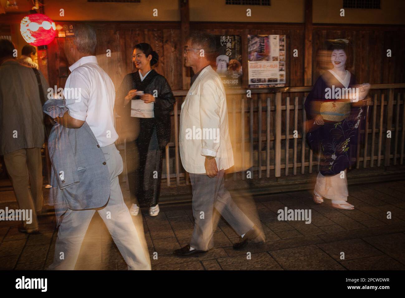 Geishas and clients in the entrance of Ochaya (tea house). Hanamikoji ...