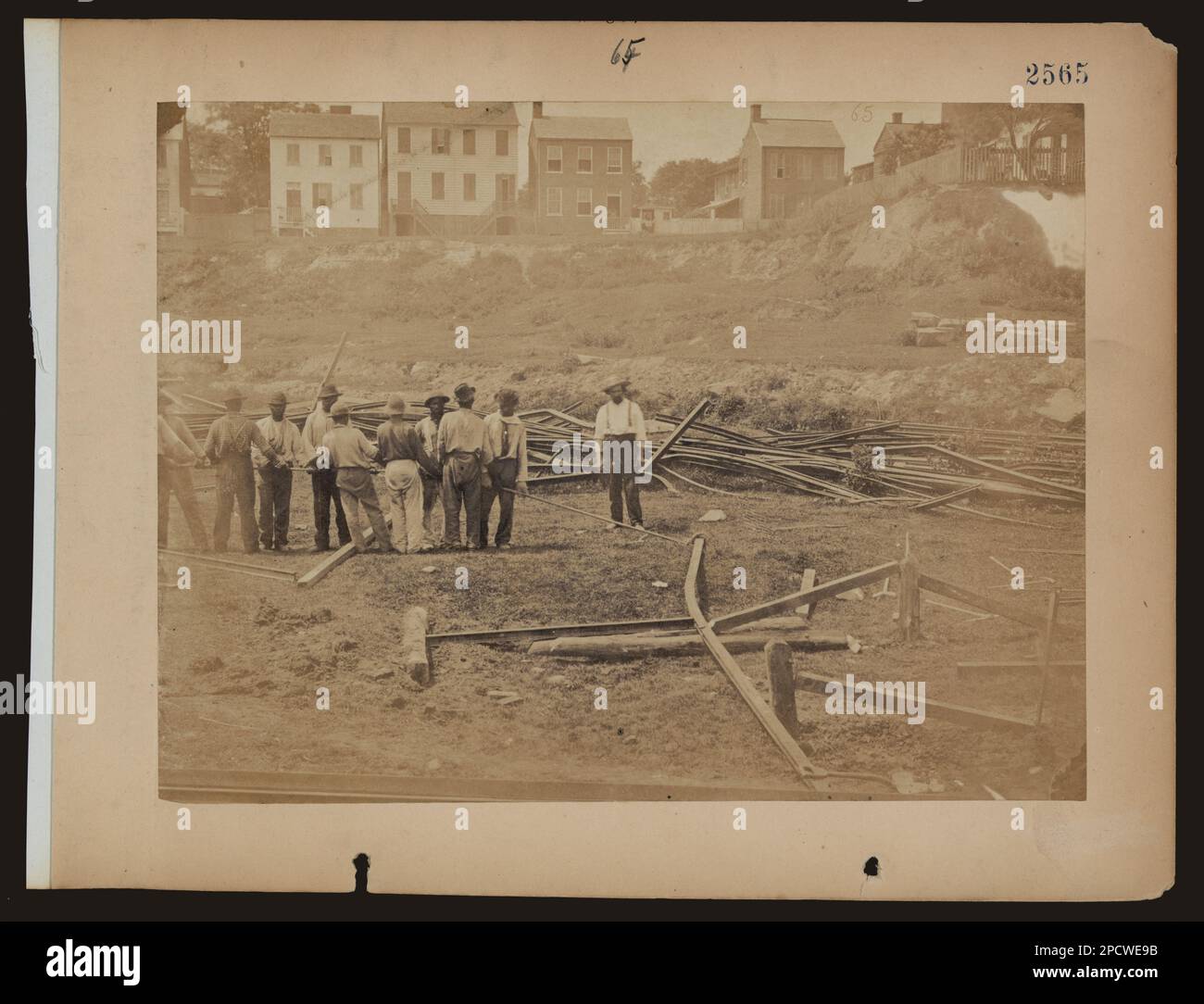 Railroad construction workers straightening track. Forms part of Civil ...
