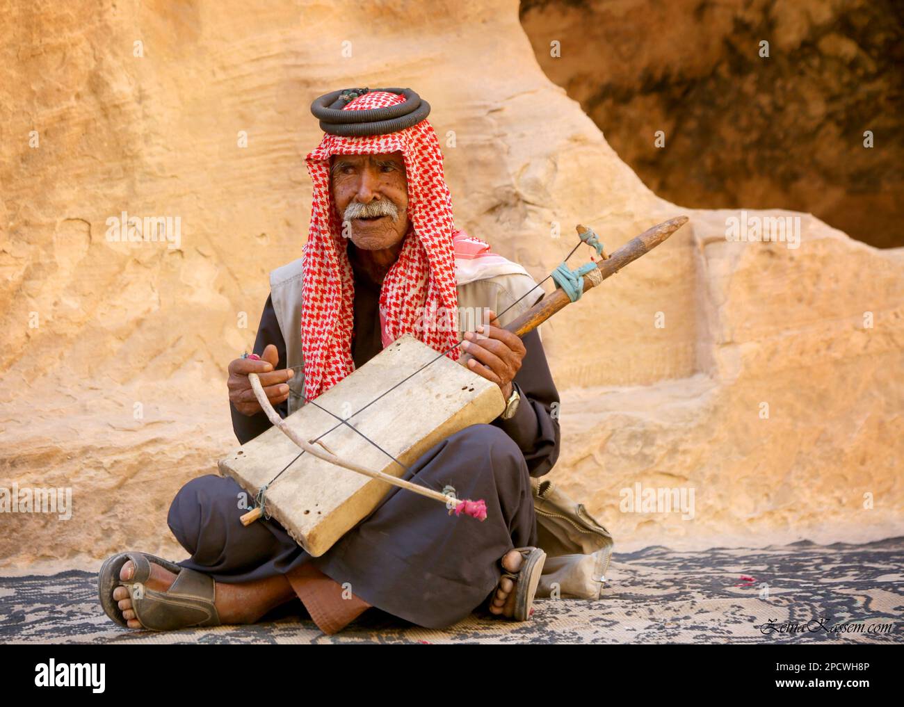 Old local playing music in little Petra Stock Photo - Alamy