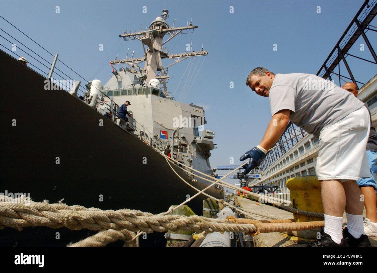 Line handler Anthony Ferrara, of Northbridge, Mass., works to secure ...