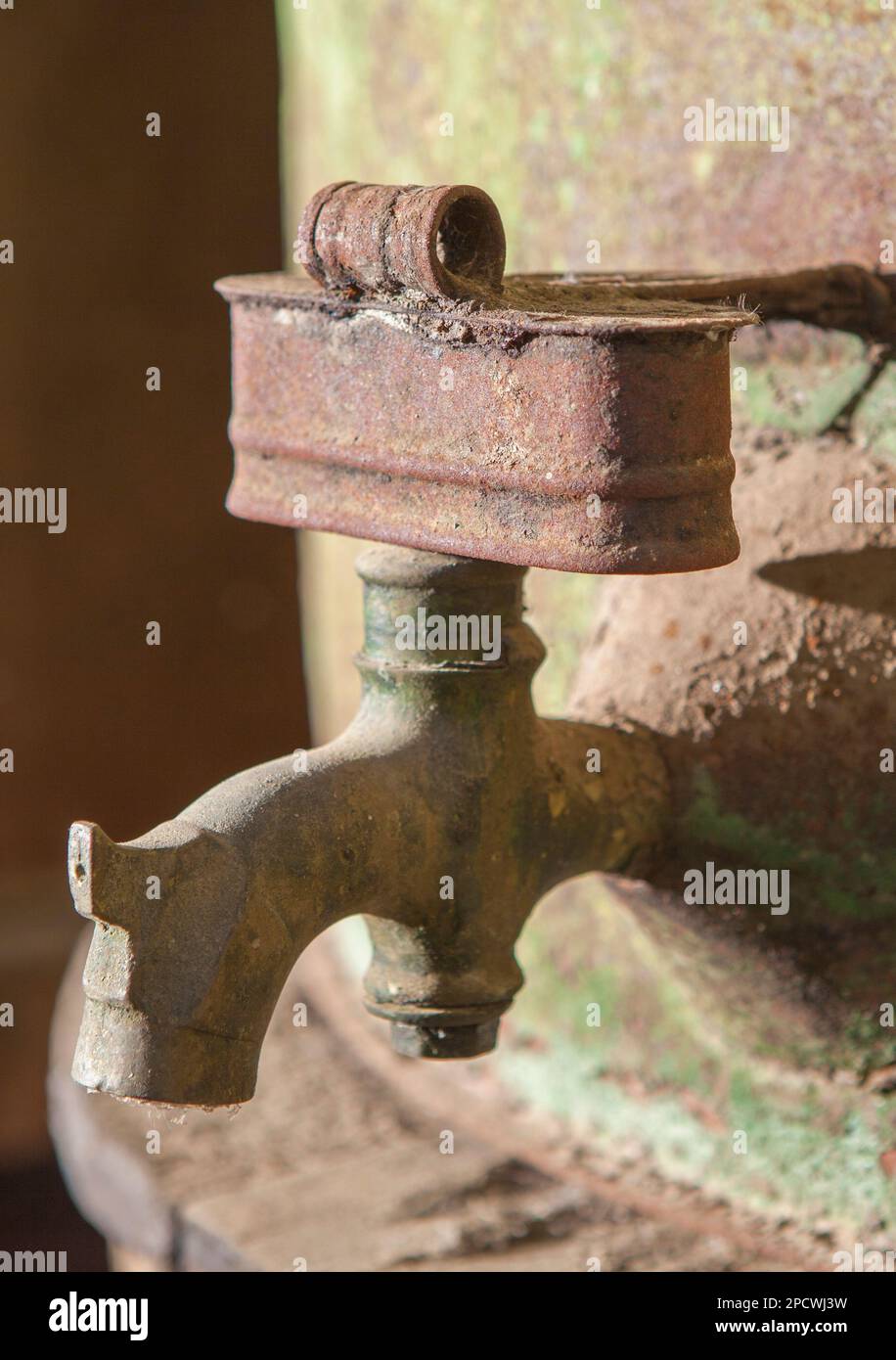 Rusty faucet detail from old olive oil drum. Old farm background Stock ...