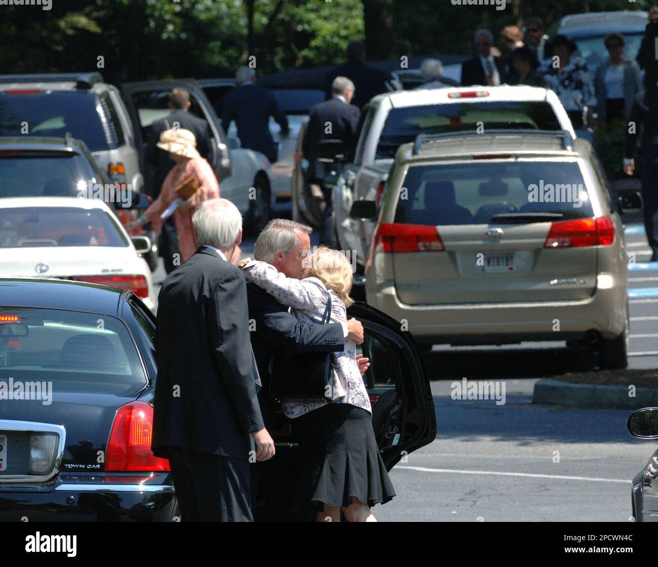 Unidentified mourners hug after a funeral service for Patsy Ramsey at ...