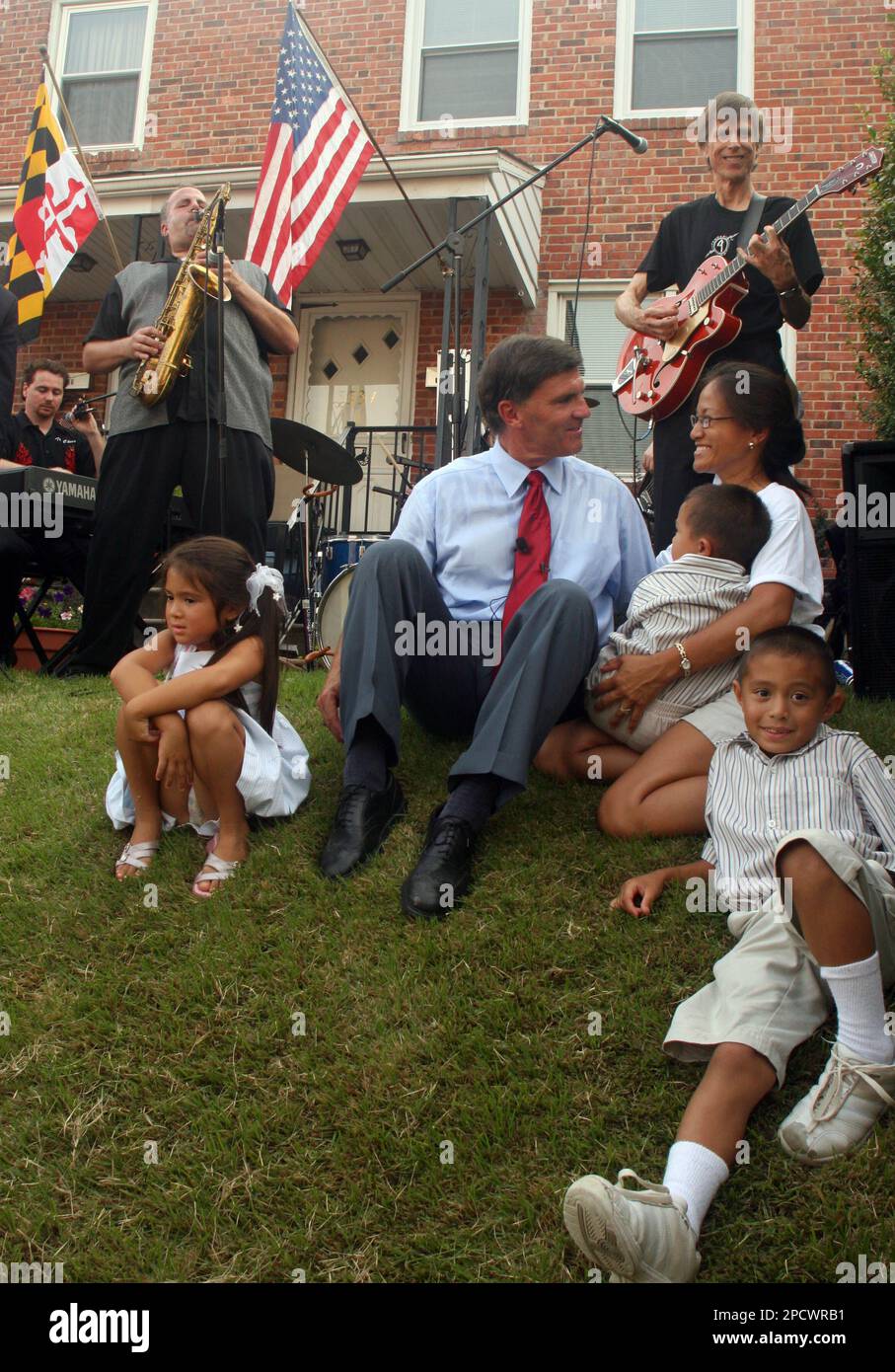 Maryland Gov. Robert Ehrlich, center, sits down in front of the home of ...