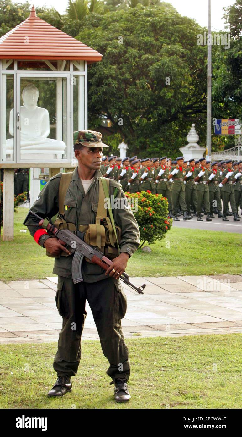 A Sri Lankan army soldier stands guard during the funeral ceremony of ...