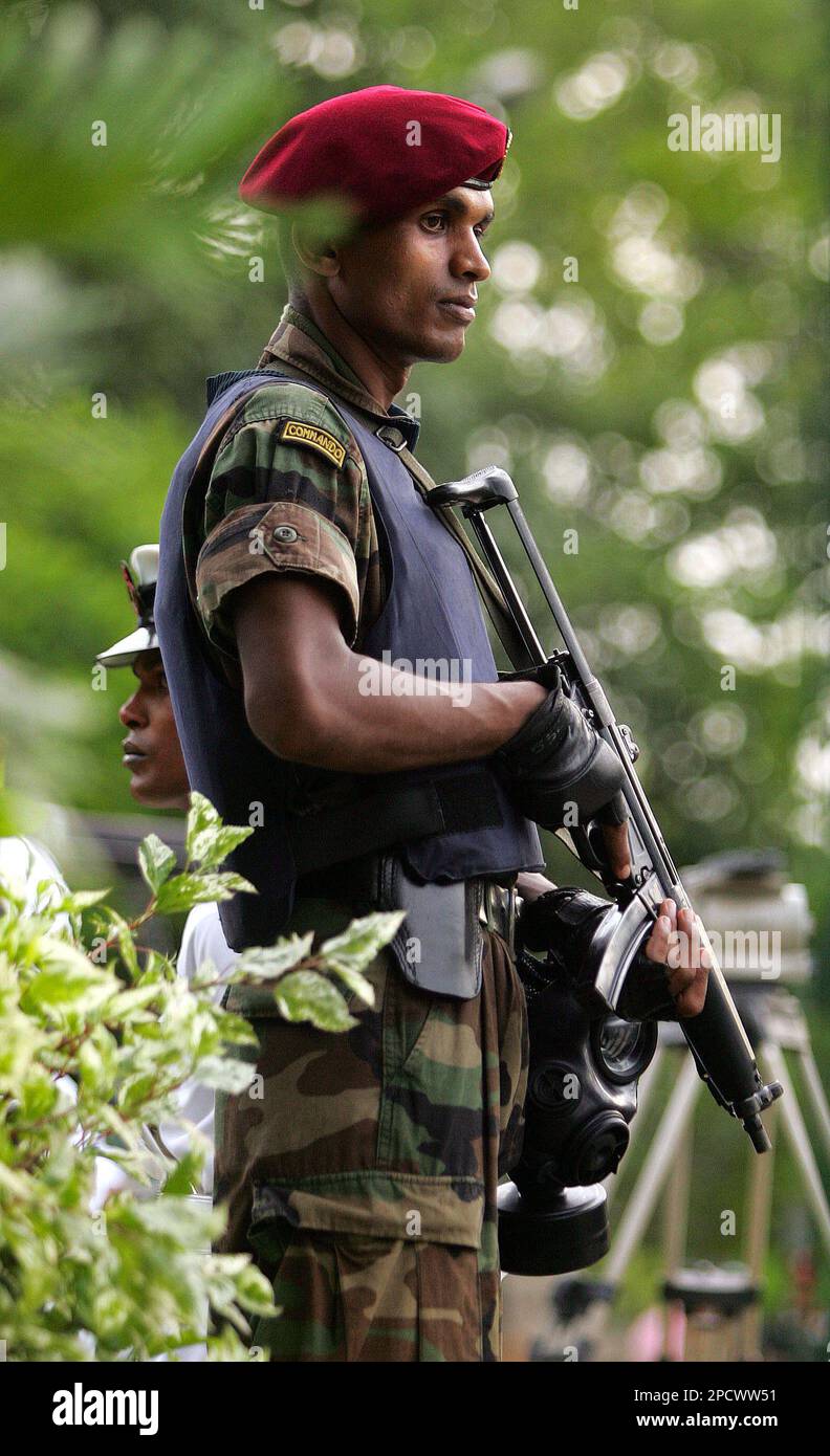 A Sri Lankan army soldier stands guard during the funeral ceremony of ...