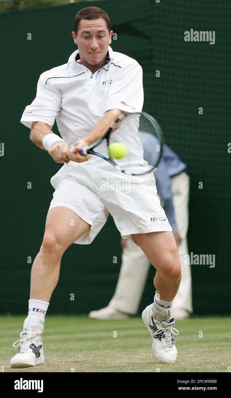 Britain's Alan Mackin returns a shot from Marcos Baghdatis of Cyprus ...