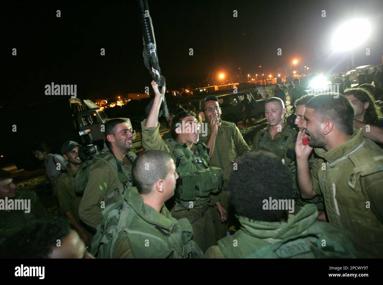 Israeli soldiers cheer as they prepare to move into the Gaza Strip at ...