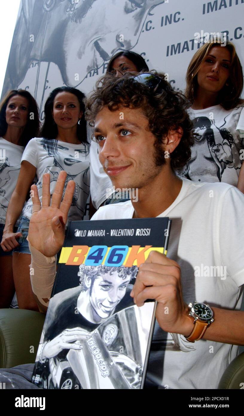 Moto GP ace reigning world champion Valentino Rossi waves as he holds ...