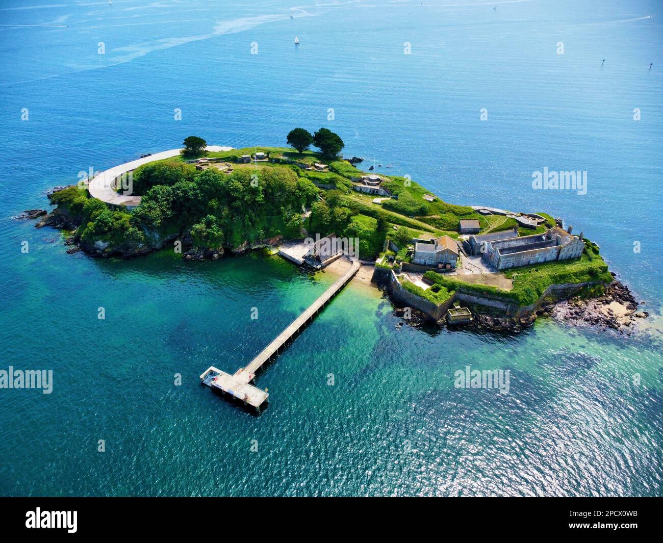 Aerial view of Drake's Island coastline with rocky shoreline and blue ...