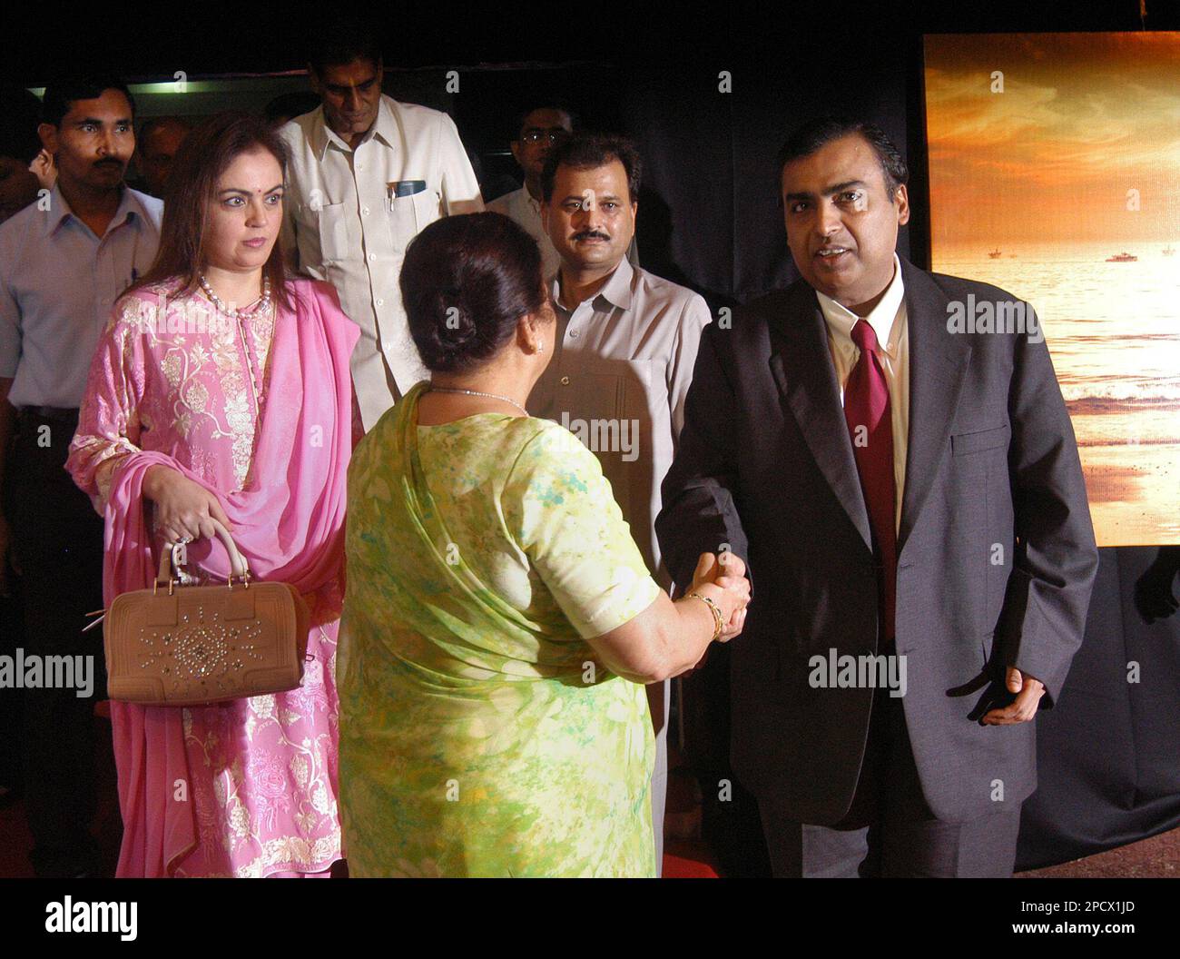 Reliance Industries Limited Chairman Mukesh Ambani, right, shakes hand ...
