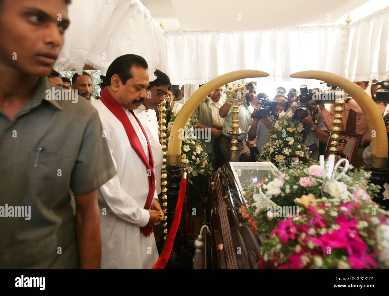 Sri Lankan president Mahinda Rajapakse, second left, pays tributes to ...
