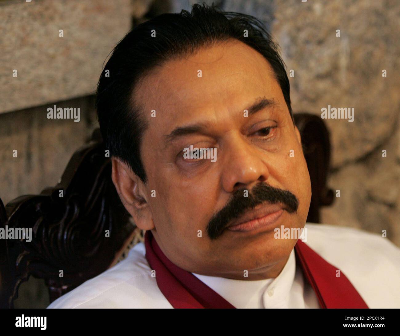 Sri Lankan President Mahinda Rajapakse looks on after paying his ...