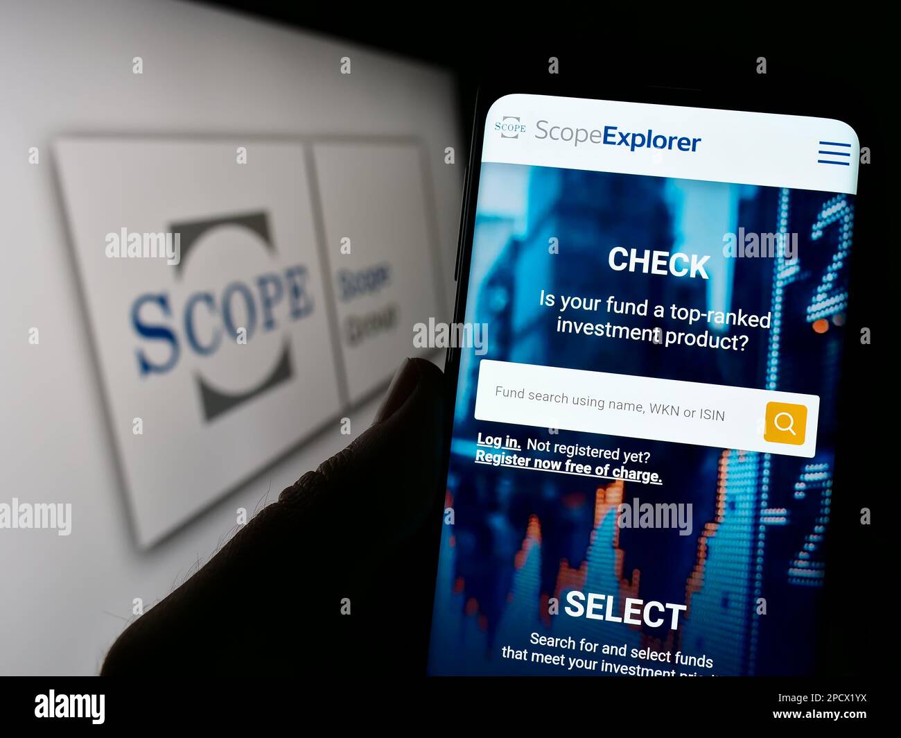 Person holding cellphone with webpage of European fund rating company ...