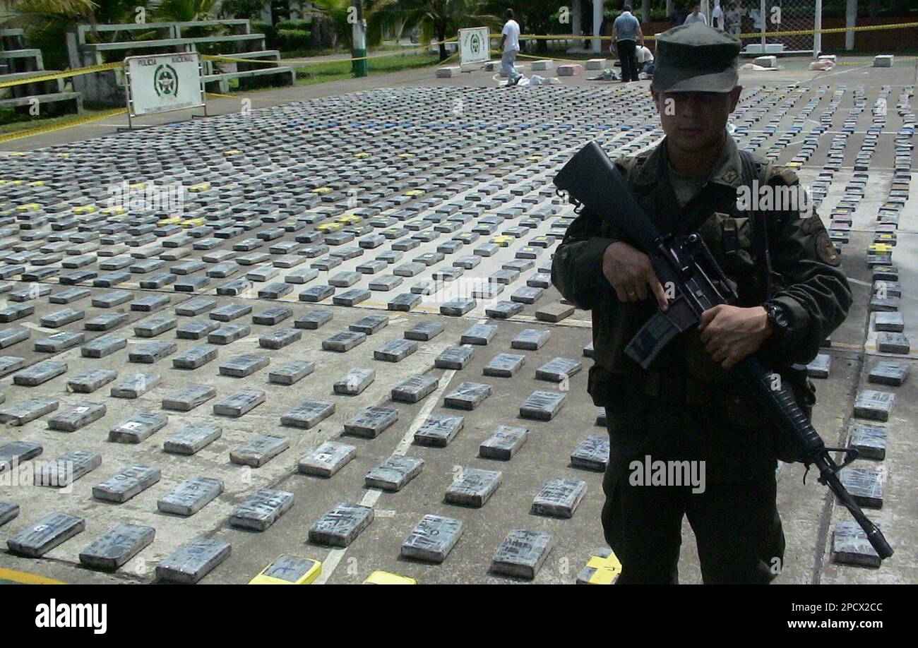 Anti-narcotics police officer guards packages of cocaine, totaling 2.9 ...