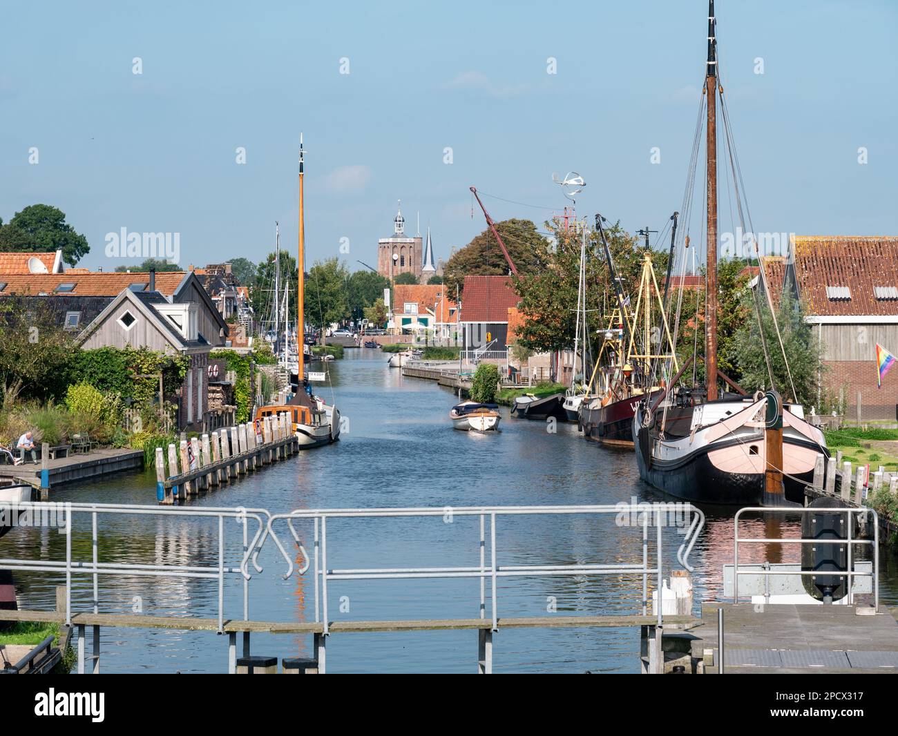 Diepe Dolte canal and church tower from locks in Workum, Friesland ...
