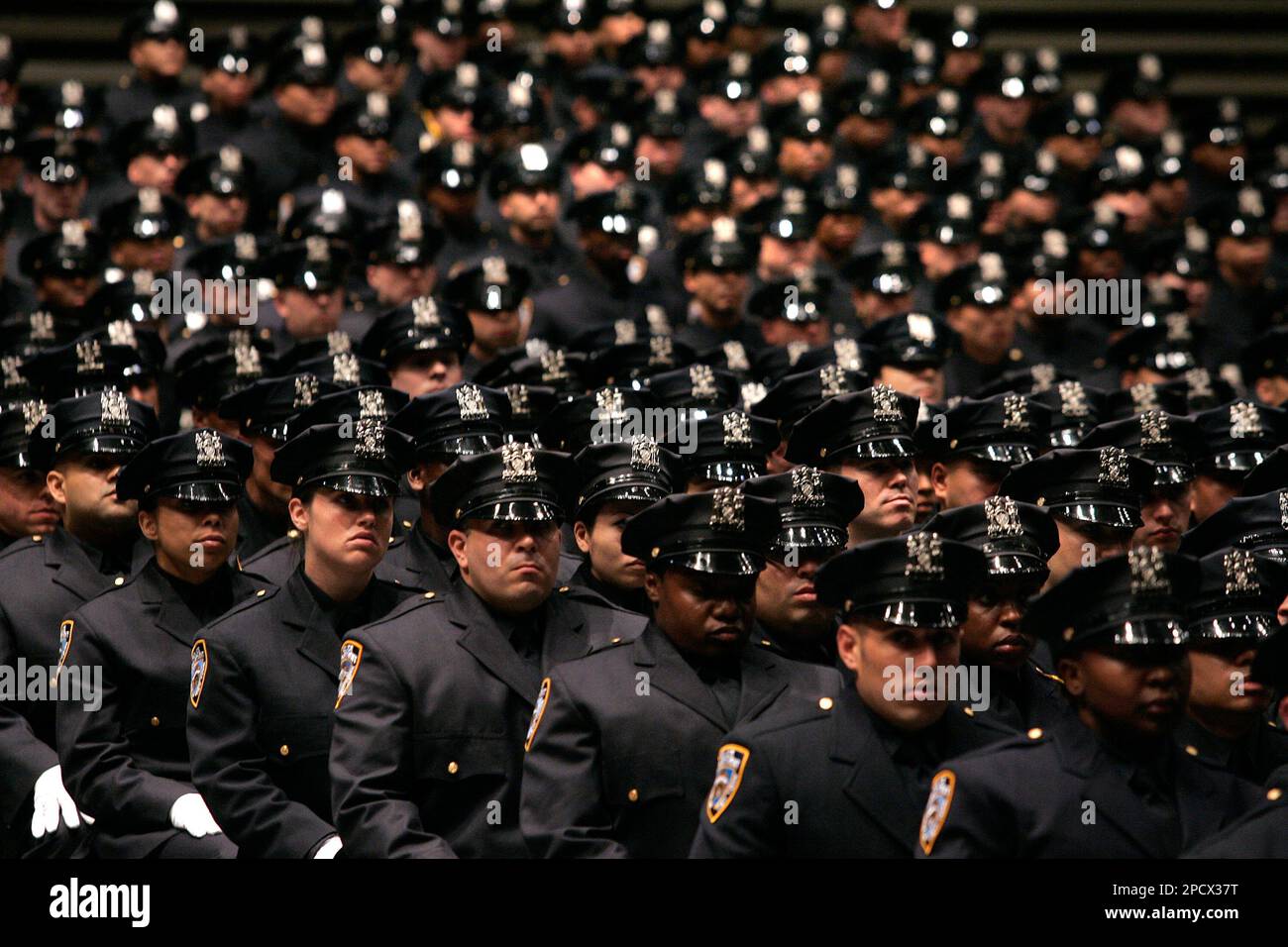 Police academy graduates attend a graduation ceremony, Monday, June 26 ...