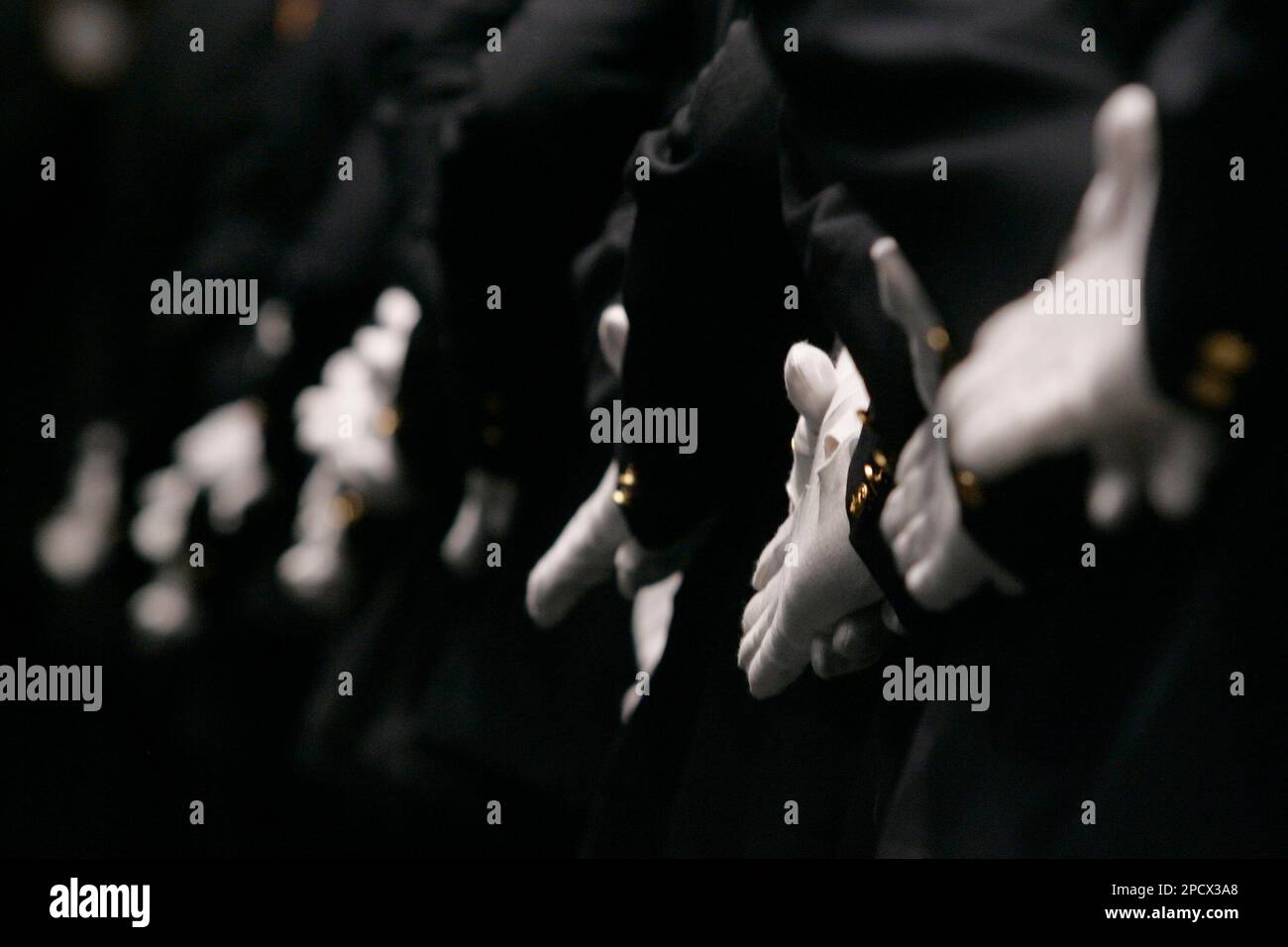 Gloves of police academy graduates are seen during a graduation ...