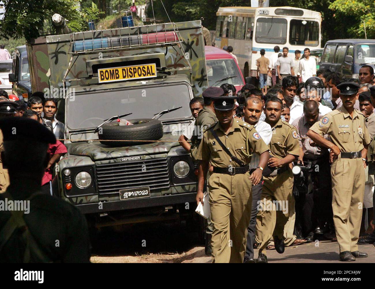 Sri Lankan army officers investigate the wreckage of a car, unseen, in ...