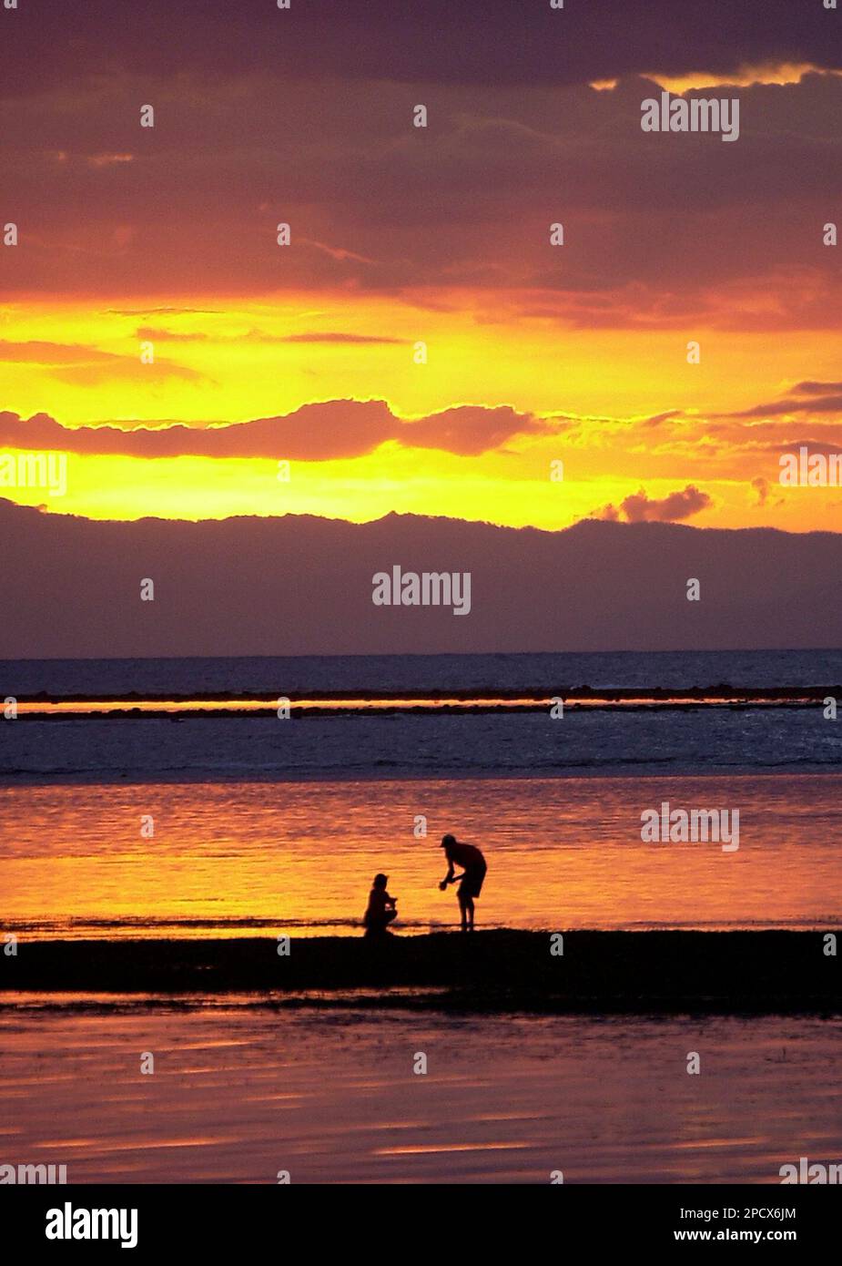 East Timorese men fish for crabs Sunday June 25, 2006 in Dili, the ...
