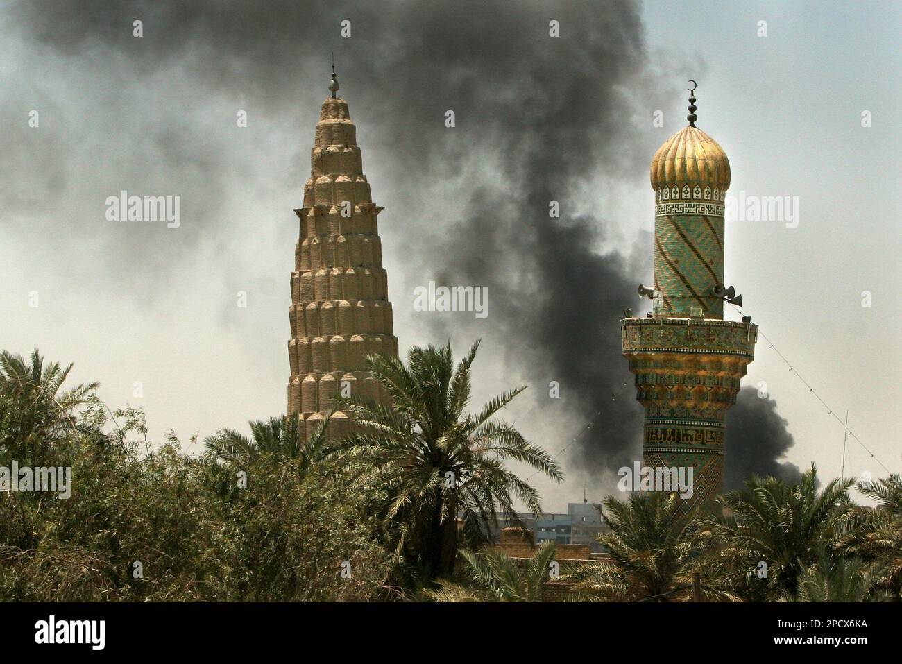 Plumes of black smoke are seen beyond the minarets over the grave of ...