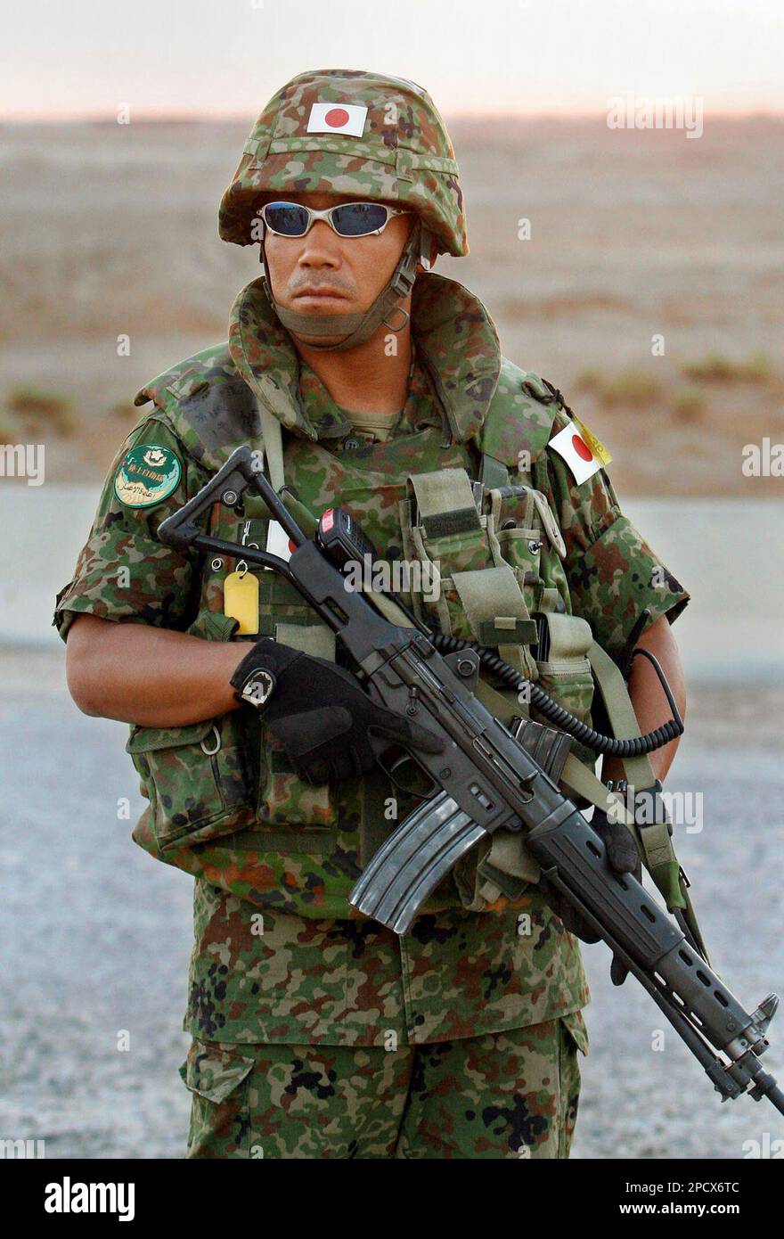 A member of the Japanese Ground Self-Defense Forces stands guard as ...
