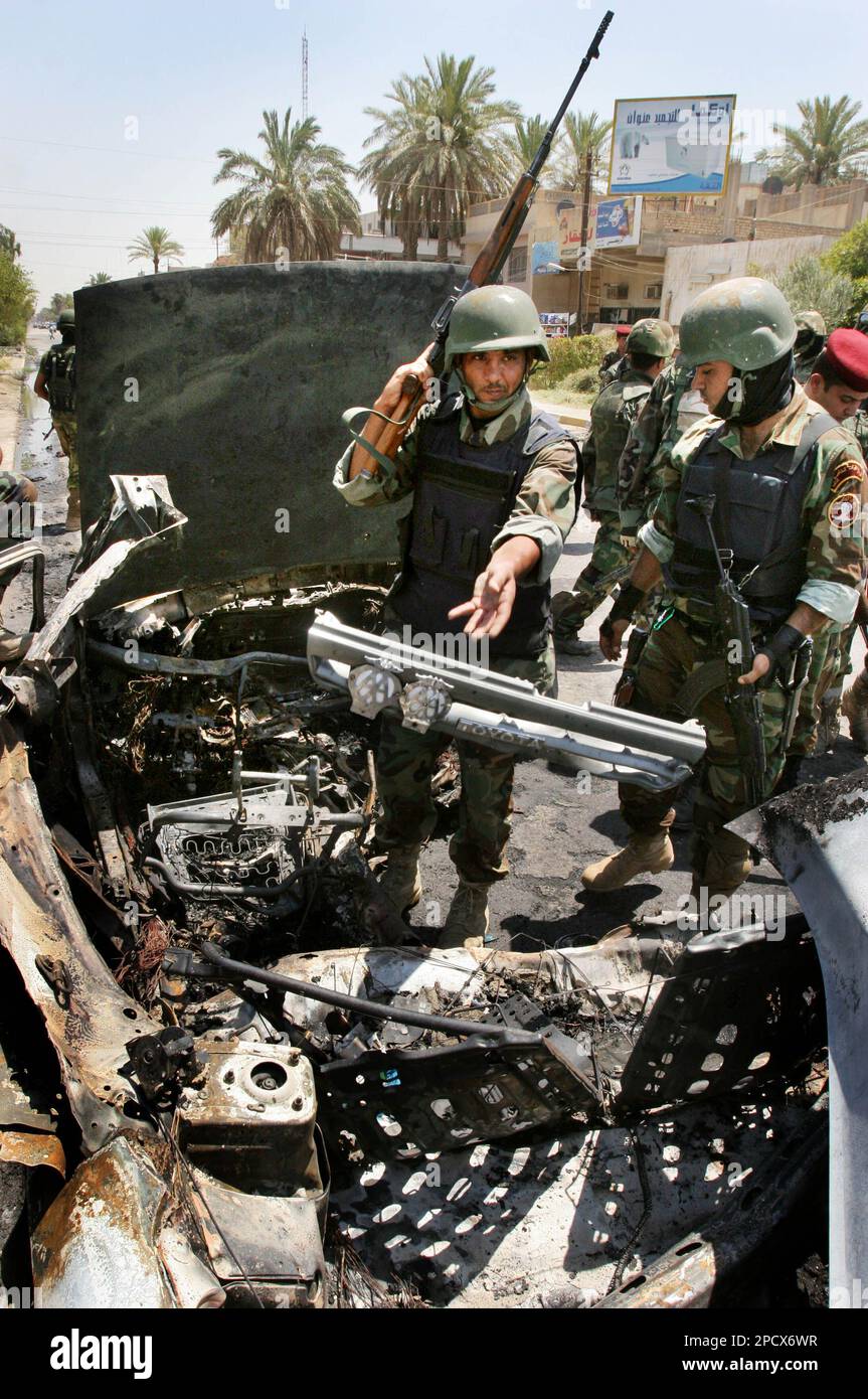 Iraqi Interior Ministry commandos attend the scene after a bomb struck ...