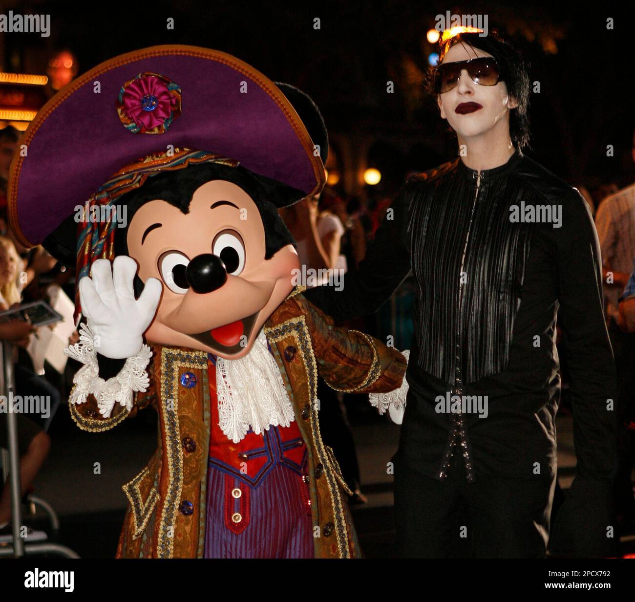 Musician Marylin Manson, right, and Mickey Mouse pose for photographers ...
