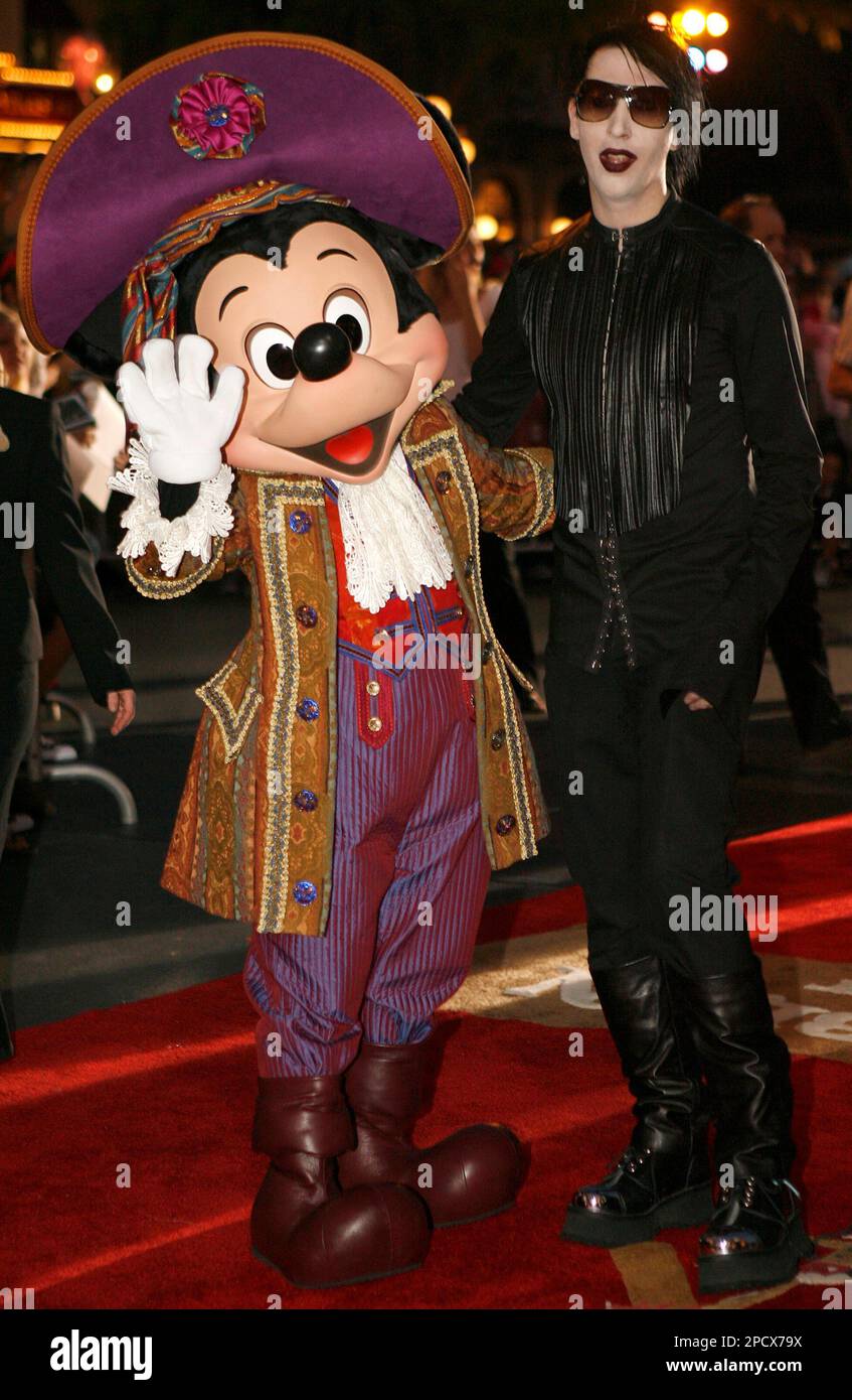 Musician Marylin Manson, right, and Mickey Mouse pose for photographers ...