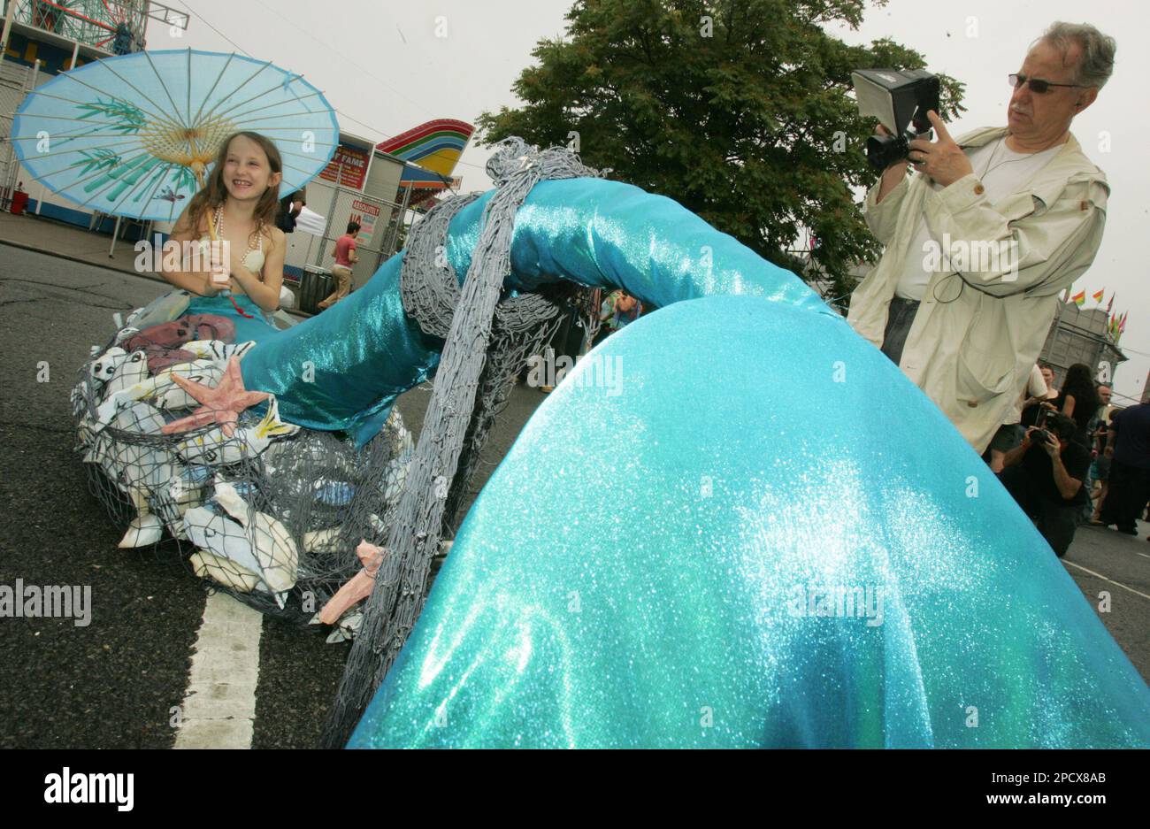 Chloe Spriggs, 7, dressed as a mermaid, smiles as she is photographed ...