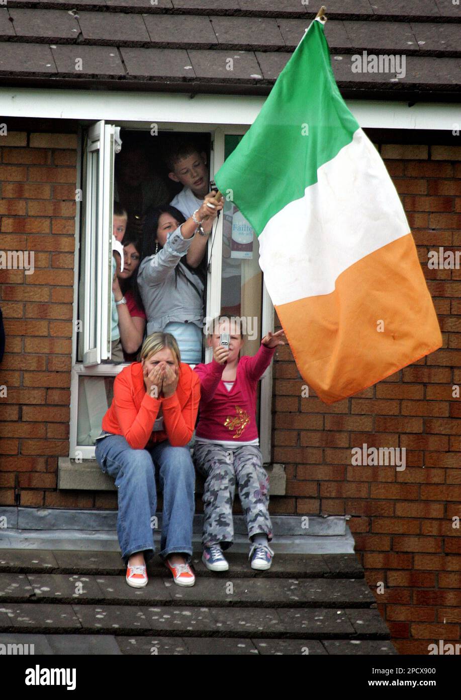 Catholic residents protest by waving the Irish flag as Protestant ...