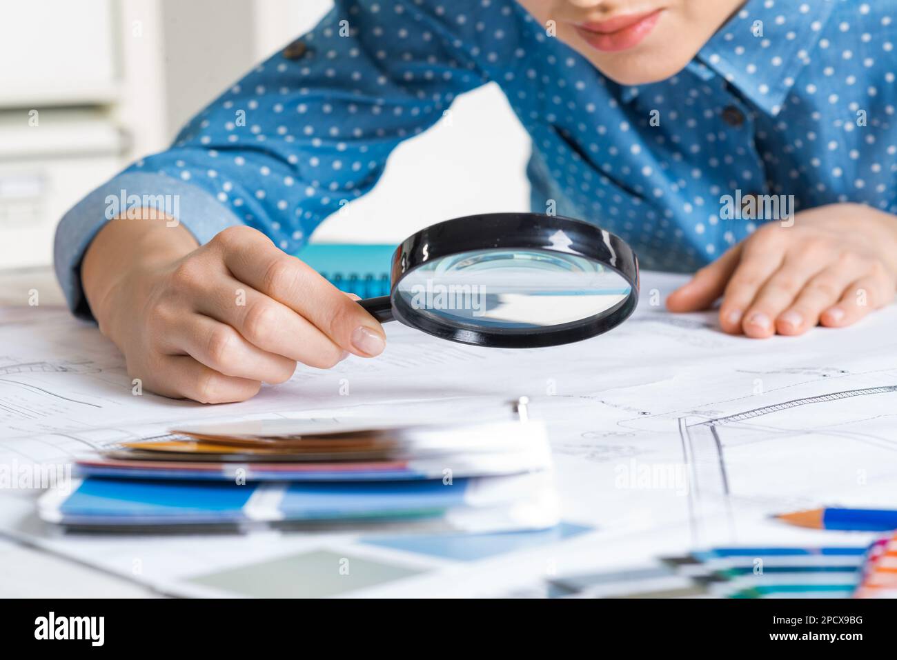 Beautiful woman studying technical drawing Stock Photo - Alamy